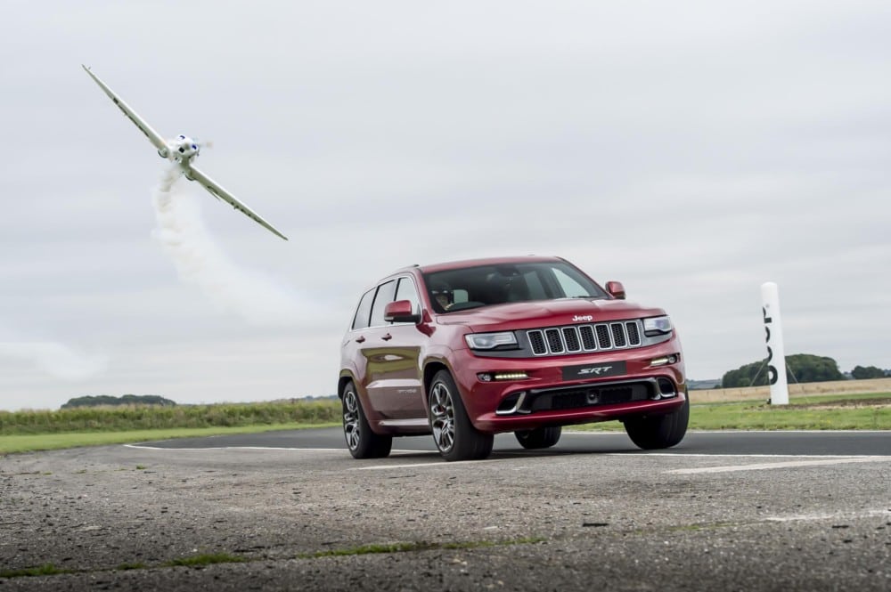 Jeep Grand Cherokee SRT races aerobatic twister plane in ultimate hot ...